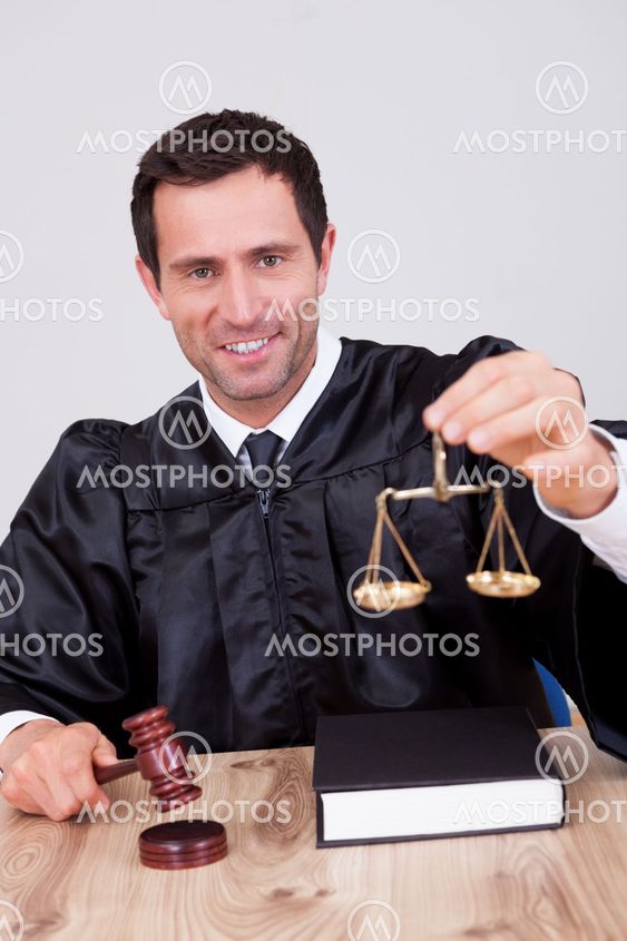 "Male Judge Holding Scale" by Andrey Popov - Mostphotos