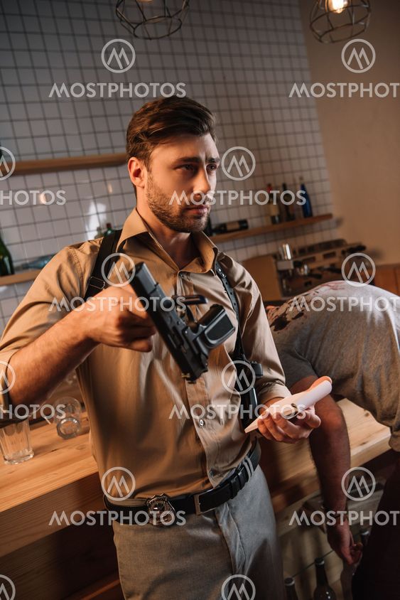 "male detective holding gun..." by LightField - Mostphotos