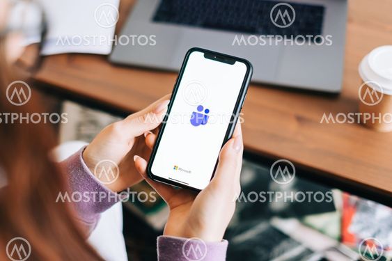 "Hand holding iPhone with Mi..." fra nikkimeel - Mostphotos